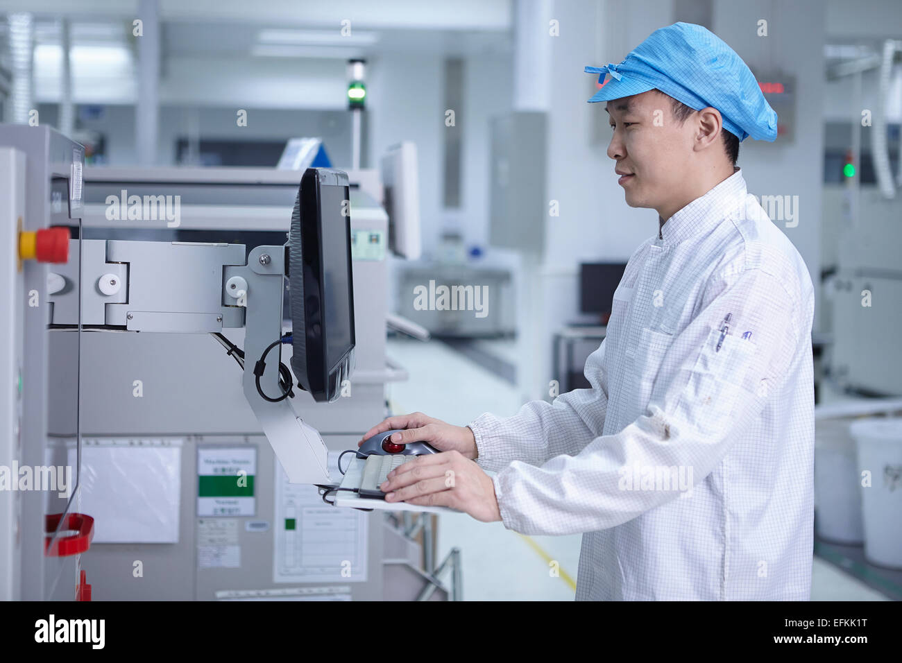 Worker using computer in factory that specialises in creating ...