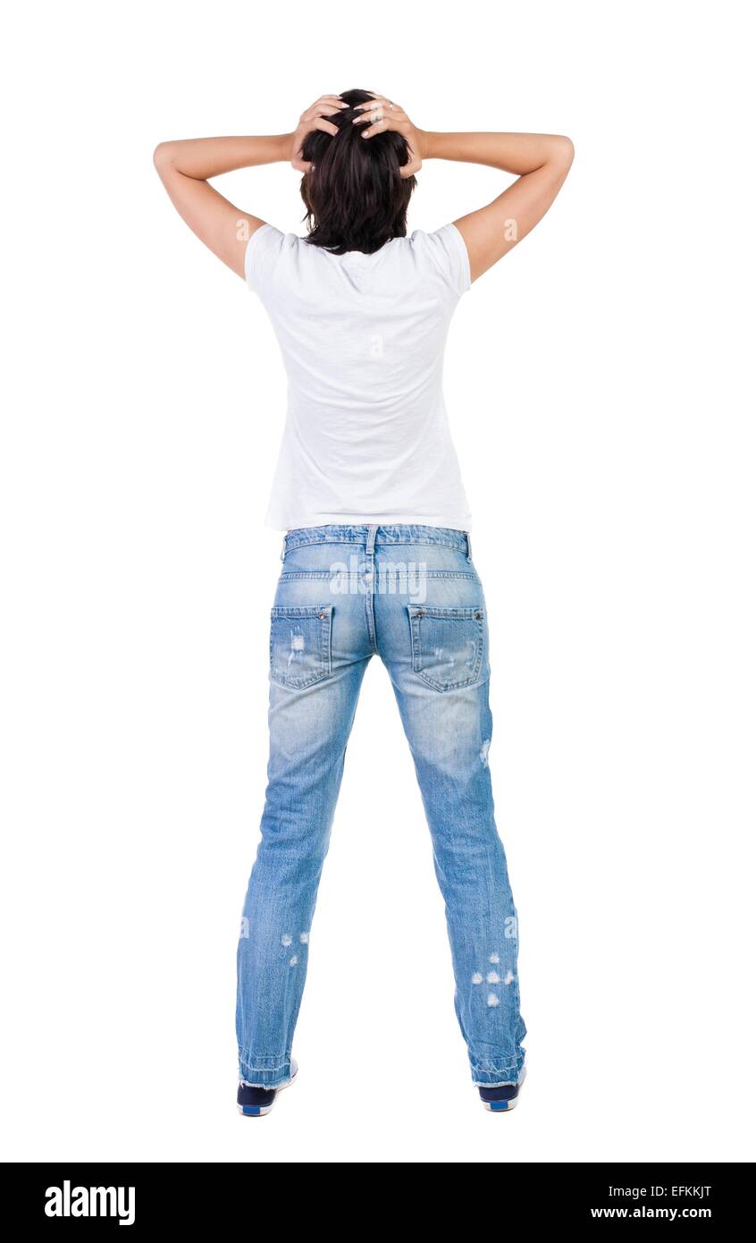 Back view of shocked woman in blue jeans. girl hid his eyes behind his ...