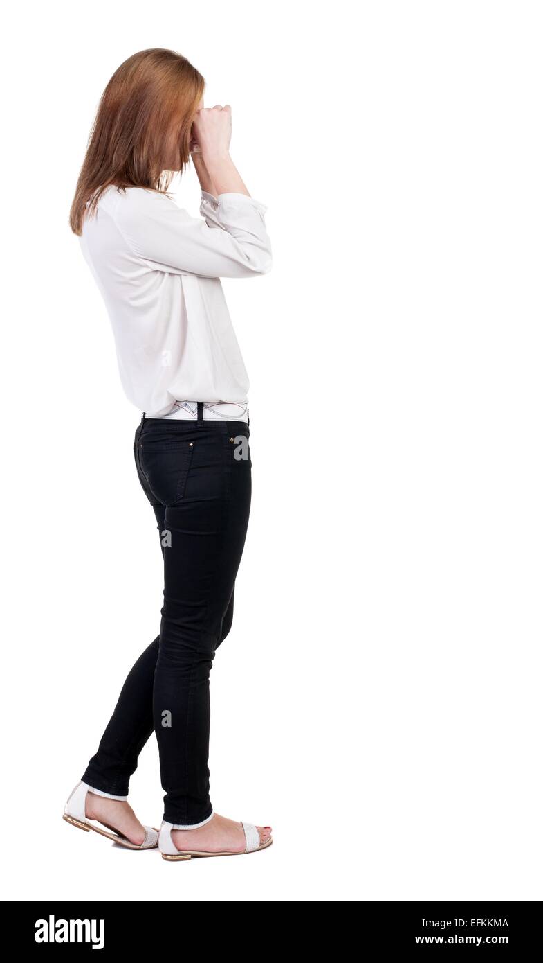 Back view of shocked woman in trousers. girl hid his eyes behind his ...