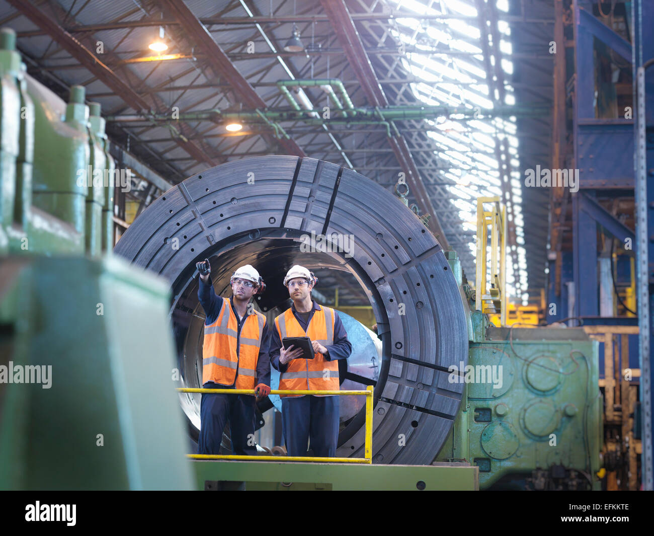 Engineers working together in engineering factory Stock Photo - Alamy