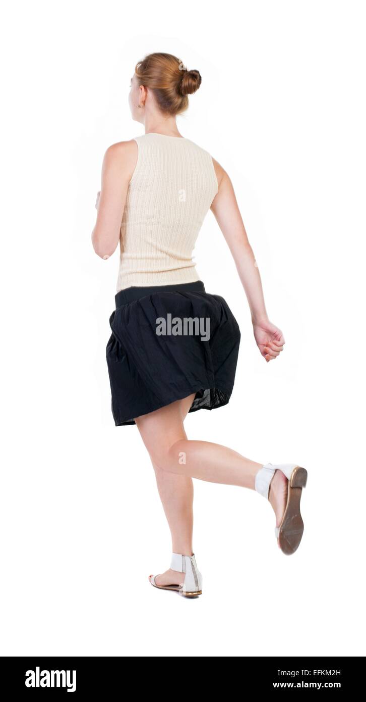 back view of running woman in dress. beautiful blonde girl in motion ...