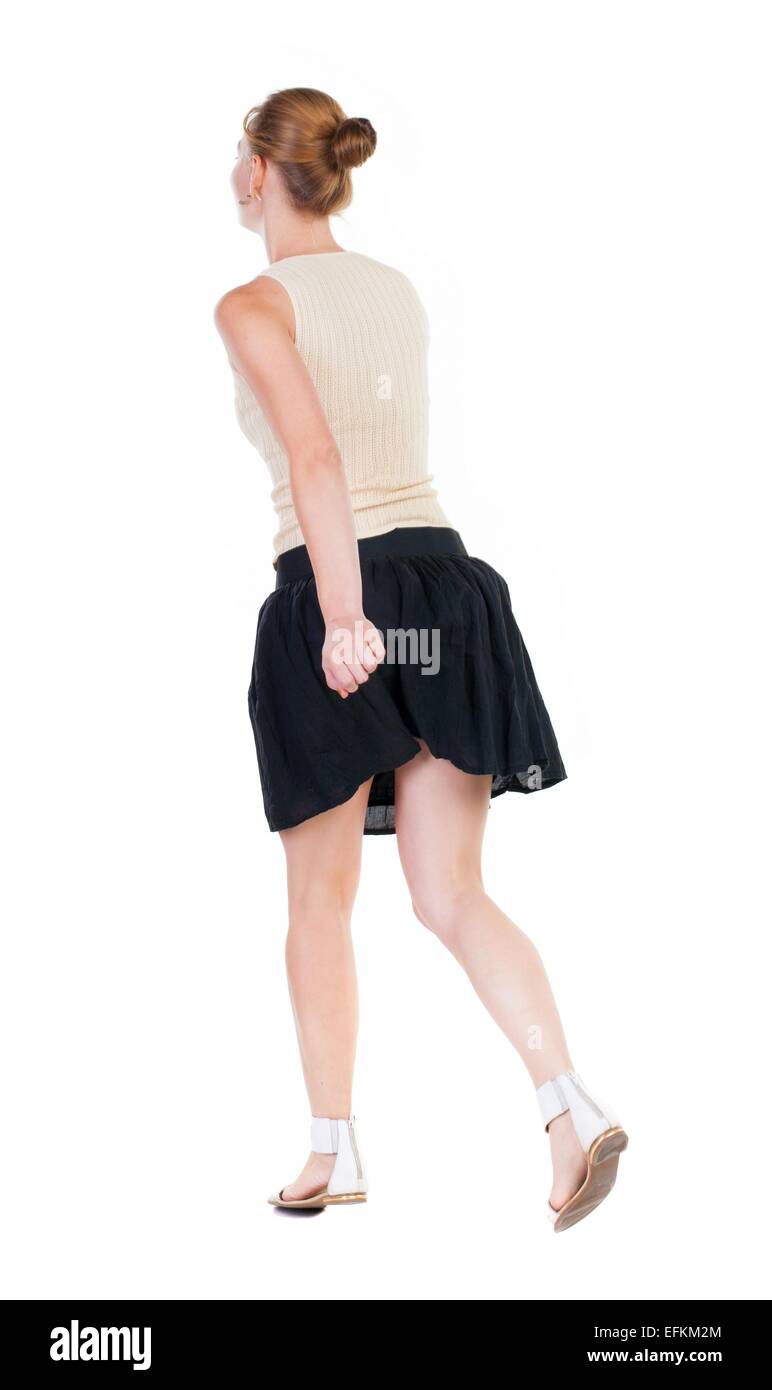 back view of running woman in dress. beautiful blonde girl in motion ...