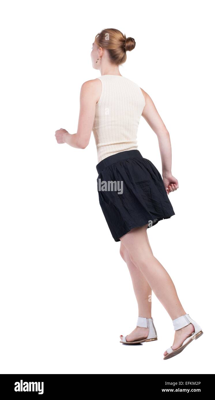 back view of running woman in dress. beautiful blonde girl in motion ...