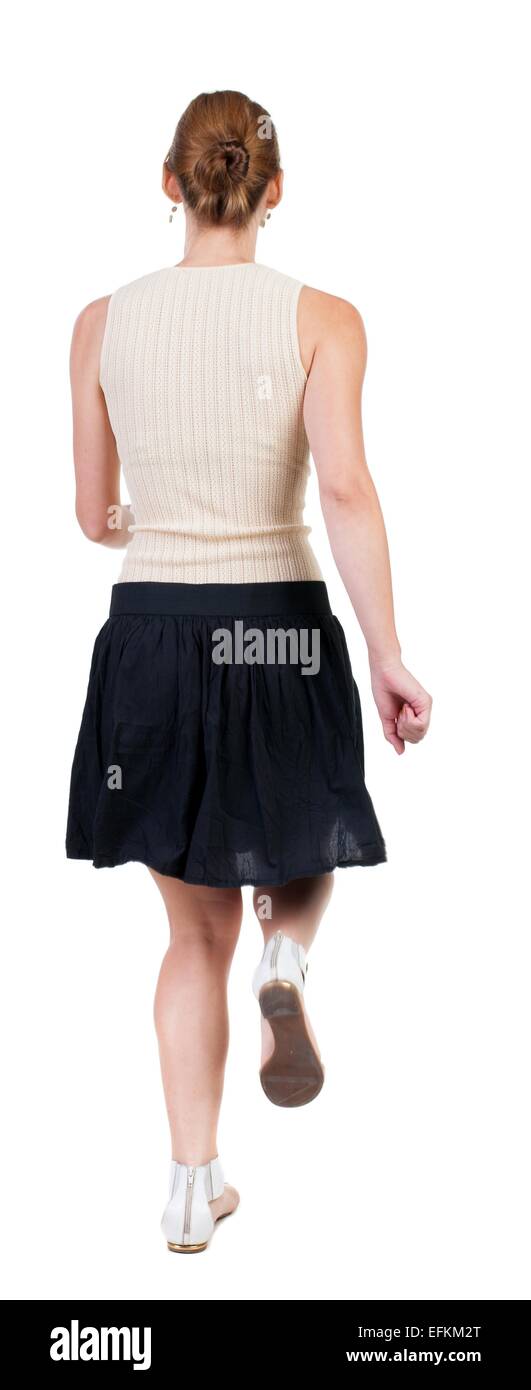 back view of running woman in dress. beautiful blonde girl in motion ...