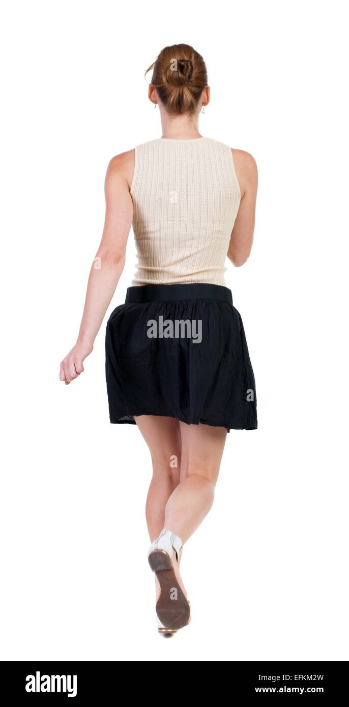 back view of running woman in dress. beautiful blonde girl in motion ...