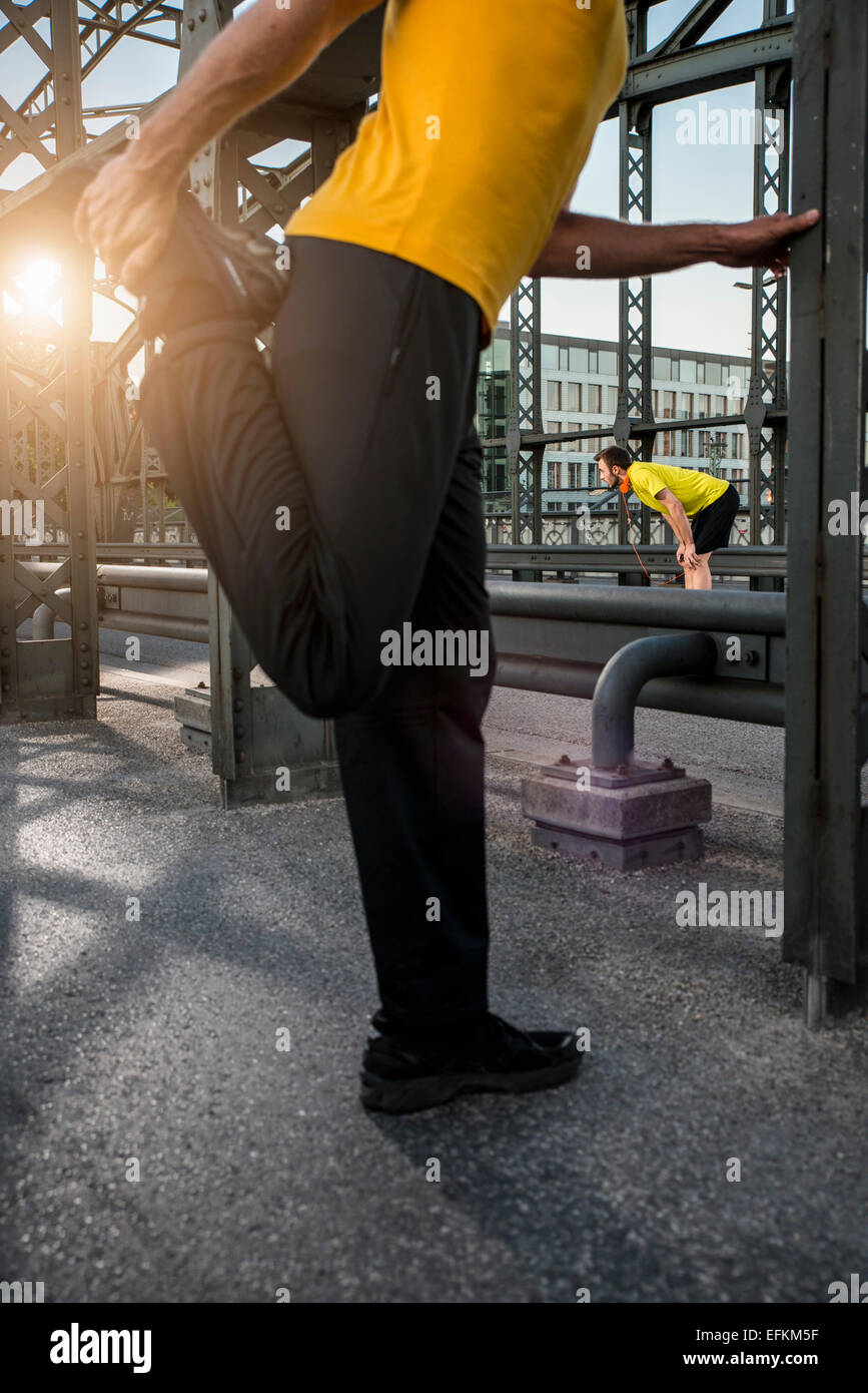 Man stretching leg on bridge, Munich, Bavaria, Germany Stock Photo - Alamy