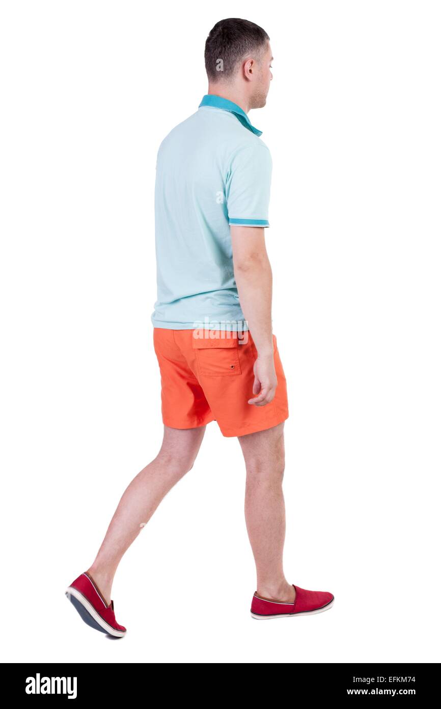 Back view of going handsome man in shorts. walking young guy . Rear ...