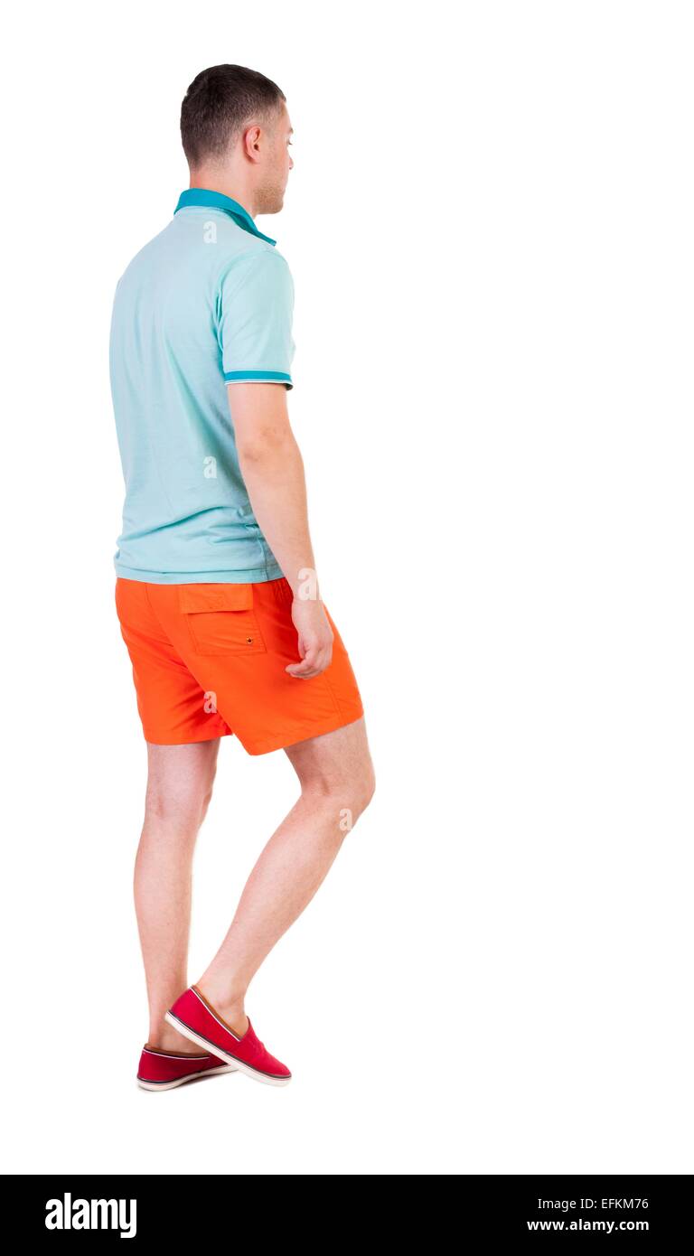 Back view of going handsome man in shorts. walking young guy . Rear ...