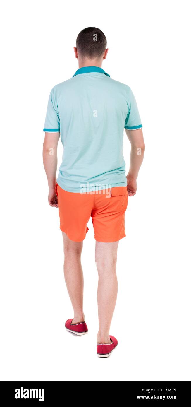 Back view of going handsome man in shorts. walking young guy . Rear ...