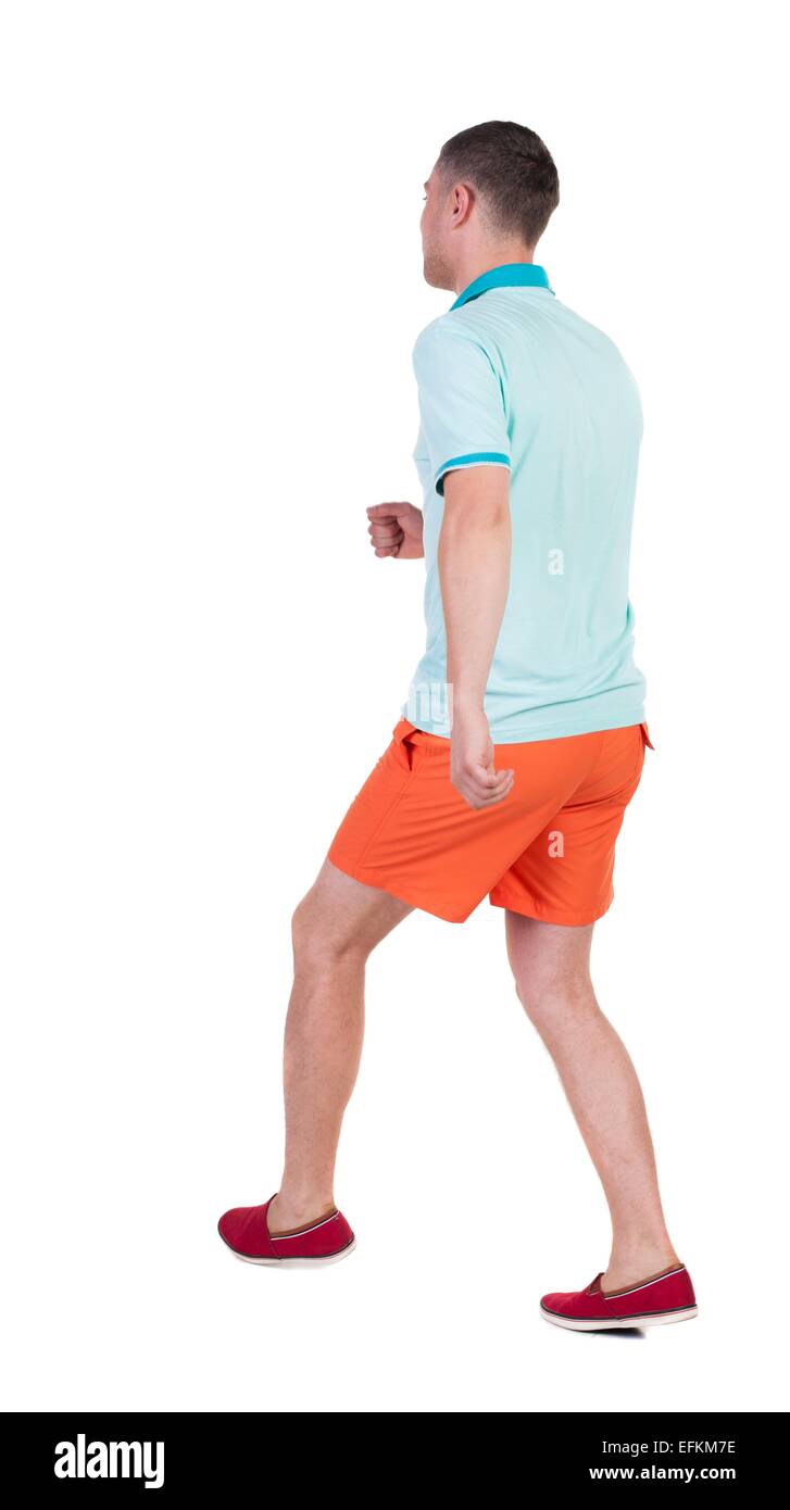 Back view of running sportsman. Man in blue t-shirt and orange shorts ...