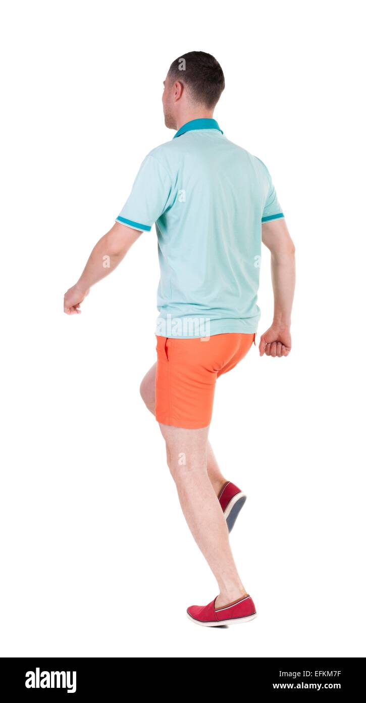Back view of running sportsman. Man in blue t-shirt and orange shorts ...