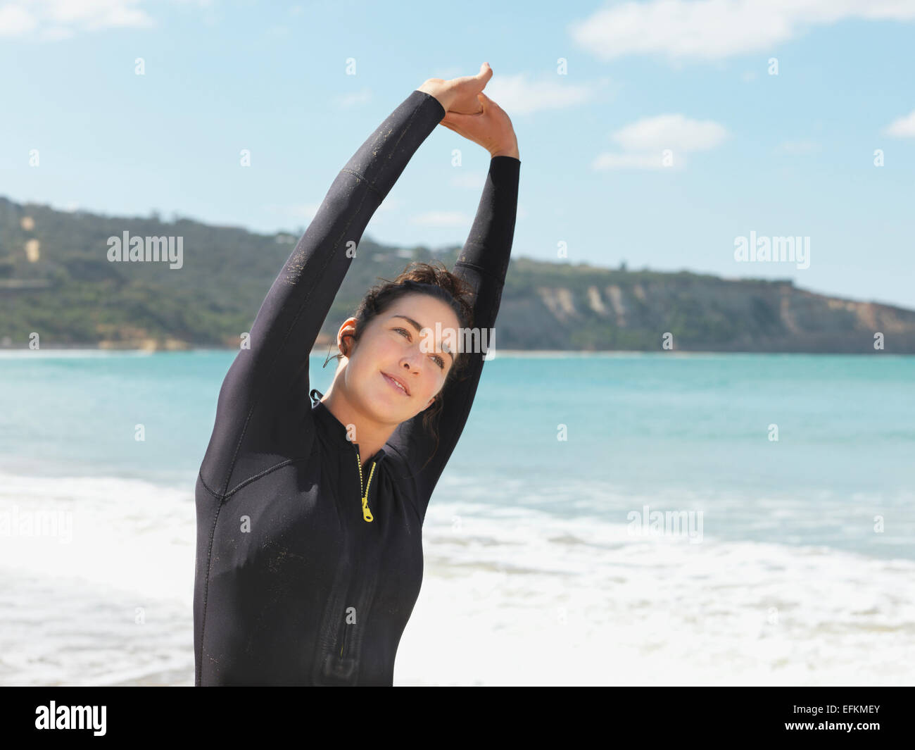 Surfer stretching on beach, Roadknight, Victoria, Australia Stock Photo ...