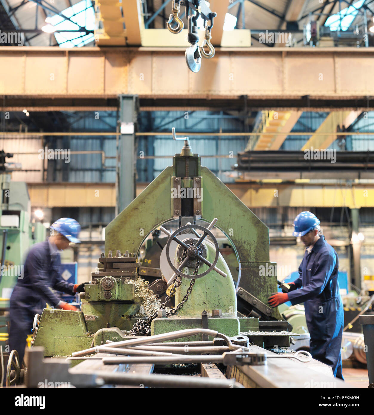 Engineers at lathe in engineering factory Stock Photo - Alamy