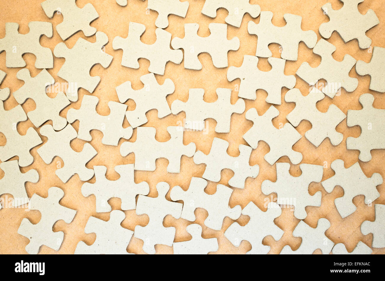 many jigsaw puzzle pieces on a paperboard surface Stock Photo - Alamy