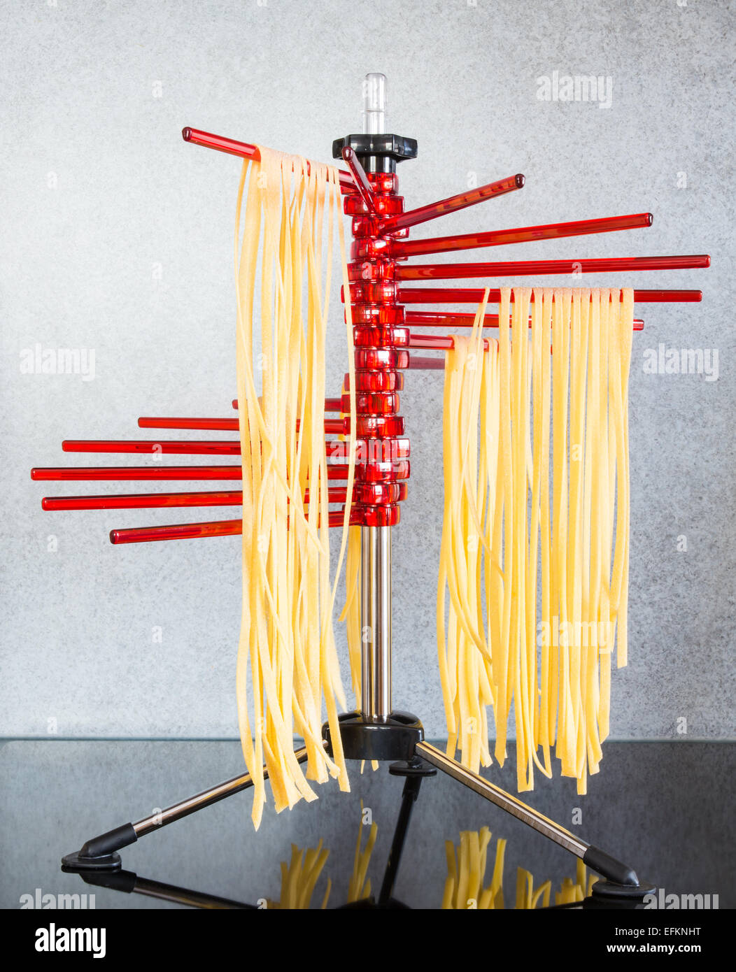 Self-made italian tagliatelle hanging on a pasta drying rack Stock ...