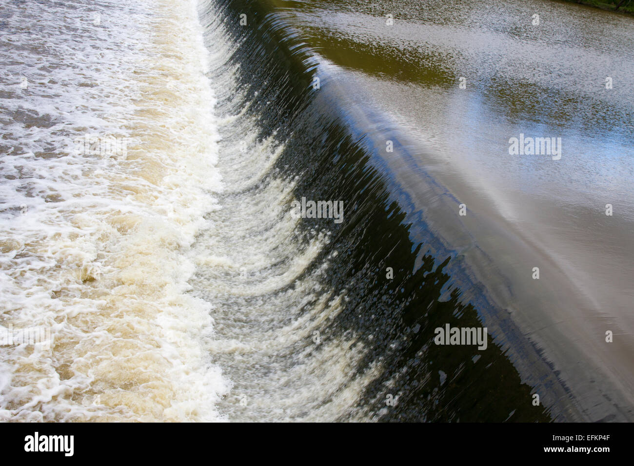 Water pouring over a dam Stock Photo - Alamy