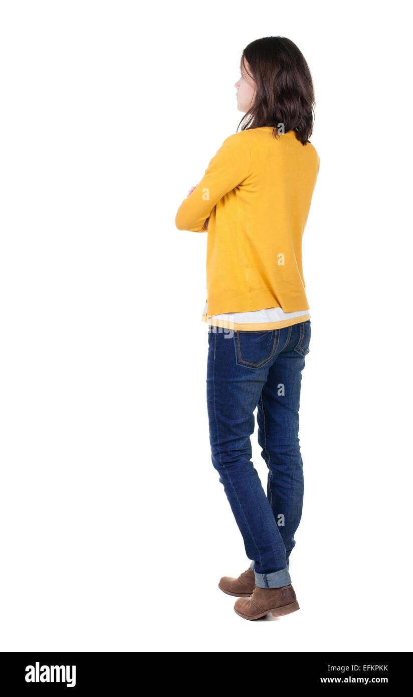 back view of standing young beautiful brunette woman in yellow pullover ...