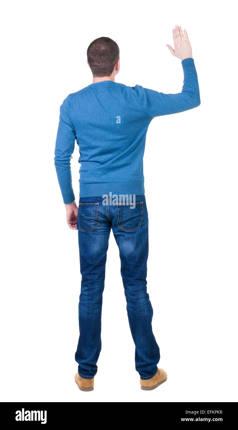 Back view of handsome man in blue pullover looking up. Standing young ...