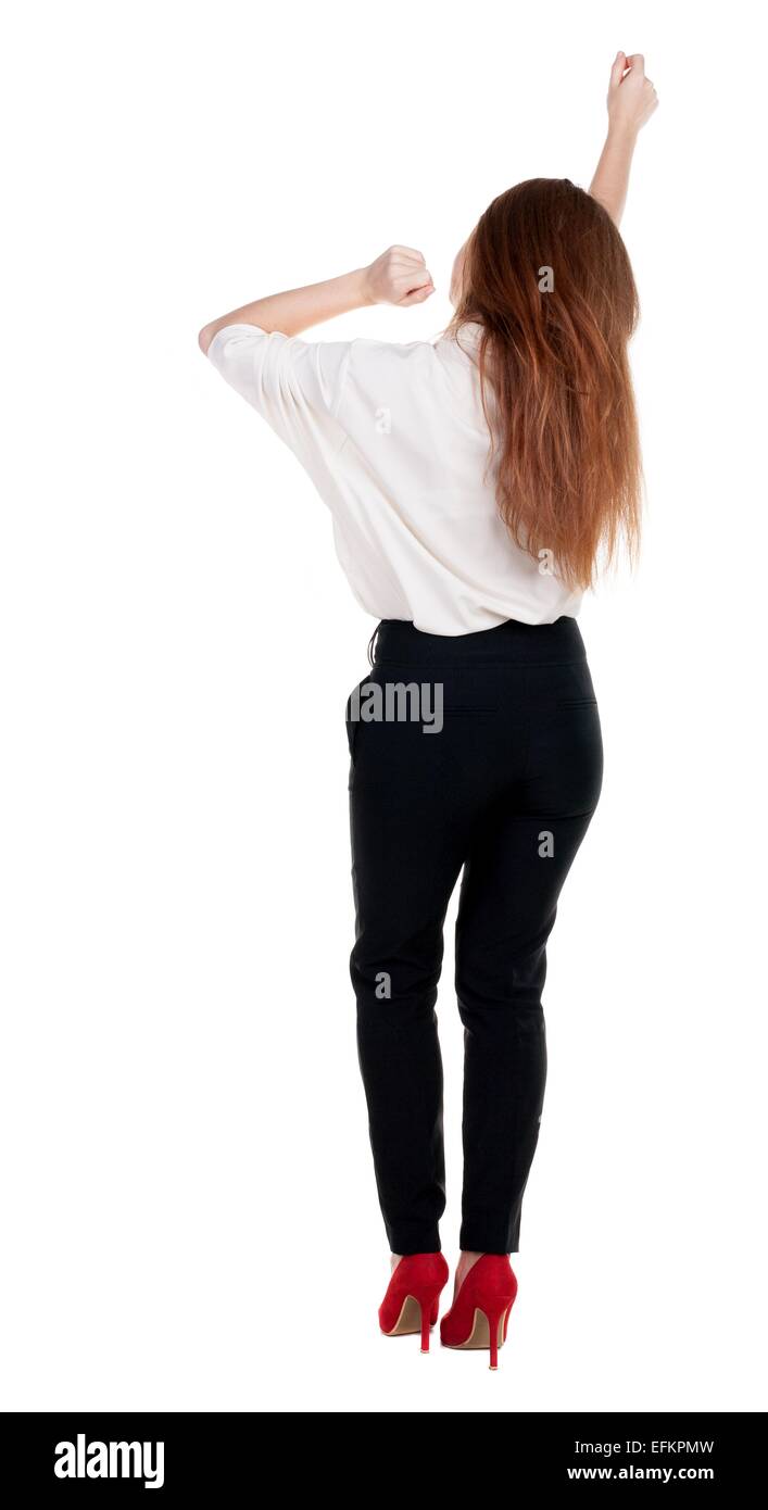 Back view of joyful woman celebrating victory hands up. Rear view ...