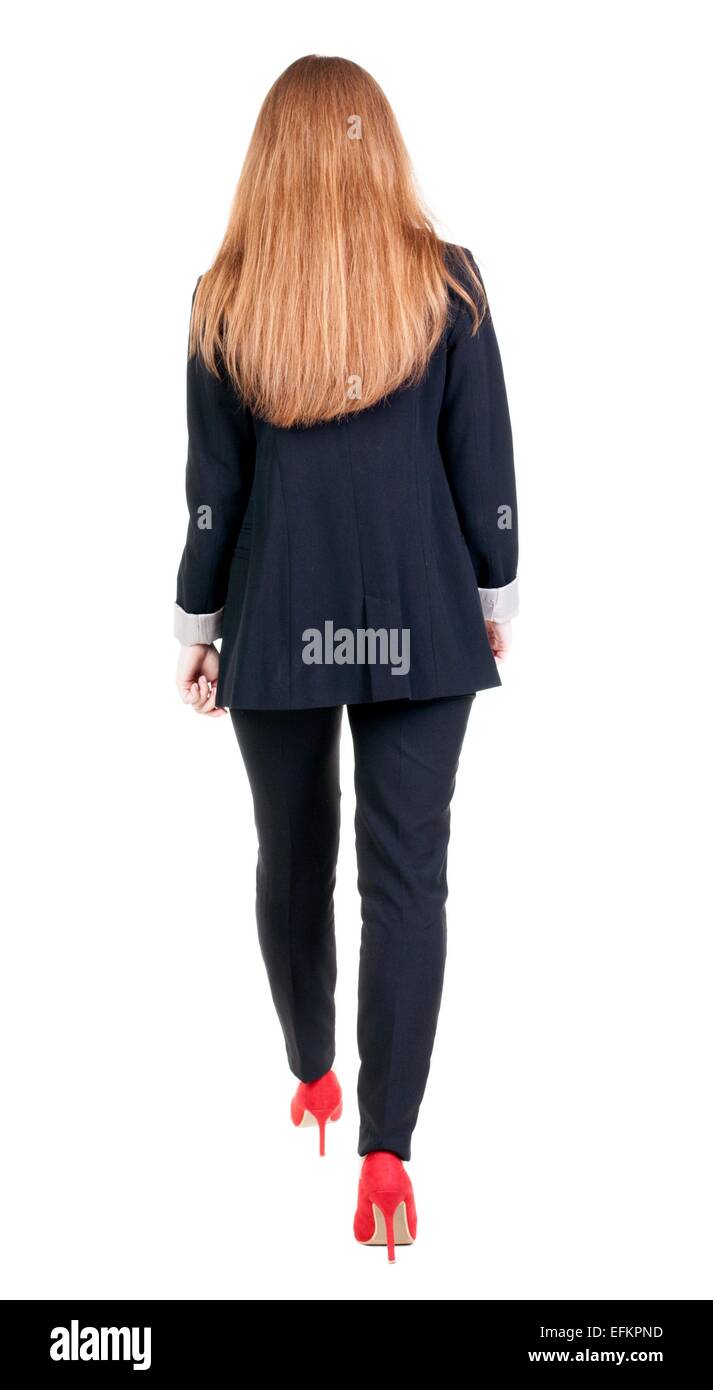walking red head business woman. back view. going young girl in suit ...