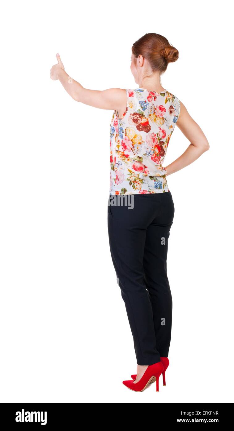 back view of standing young redhead business woman showing thumb up ...