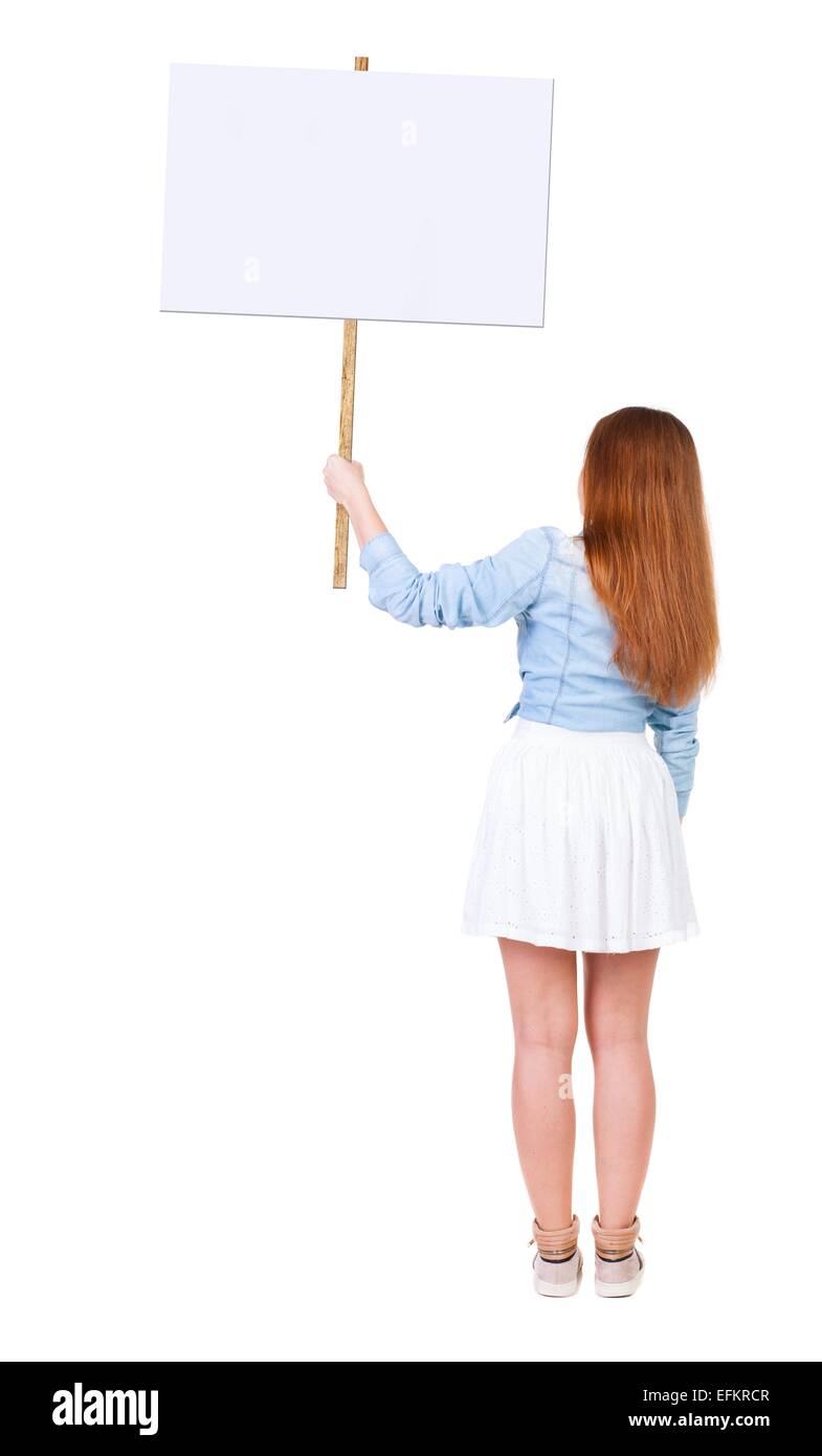 Back view of woman showing a sign board. young redhead girl holds ...