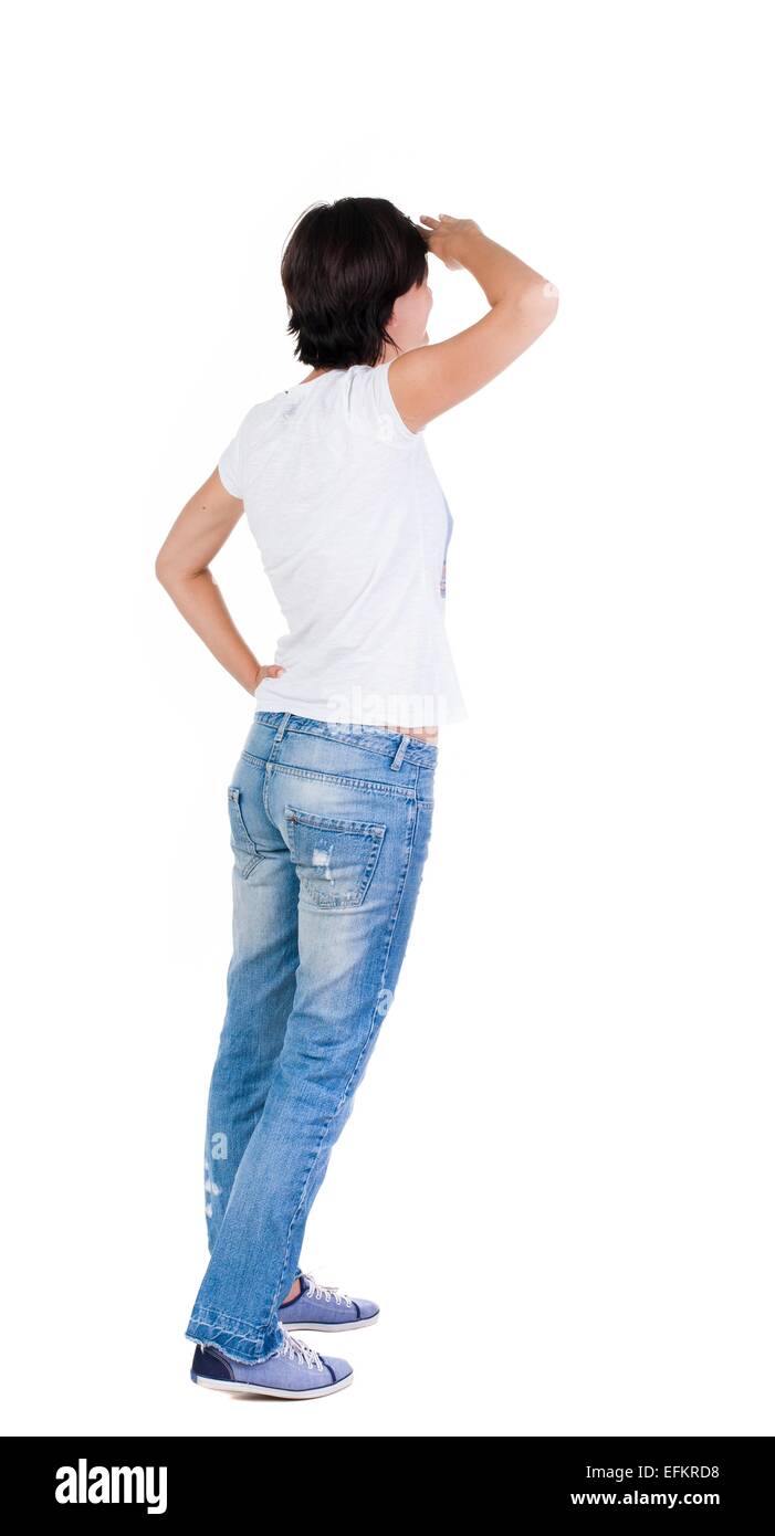 back view of standing young beautiful brunette woman. girl watching ...
