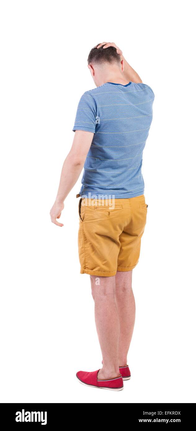 Back view of angry young man in shorts and t-shirt. Rear view. isolated ...