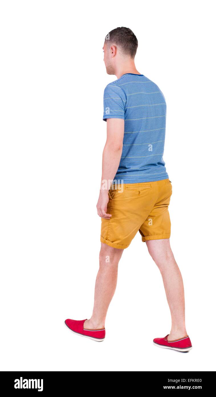 Back view of going handsome man in shorts. walking young guy . Rear ...