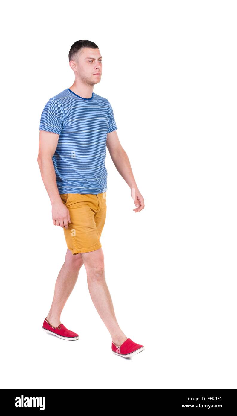 Back view of going handsome man in shorts. walking young guy . Rear ...