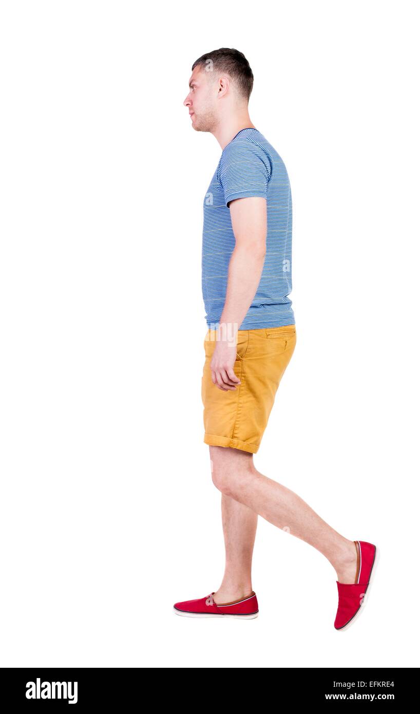 Back view of going handsome man in shorts. walking young guy . Rear ...