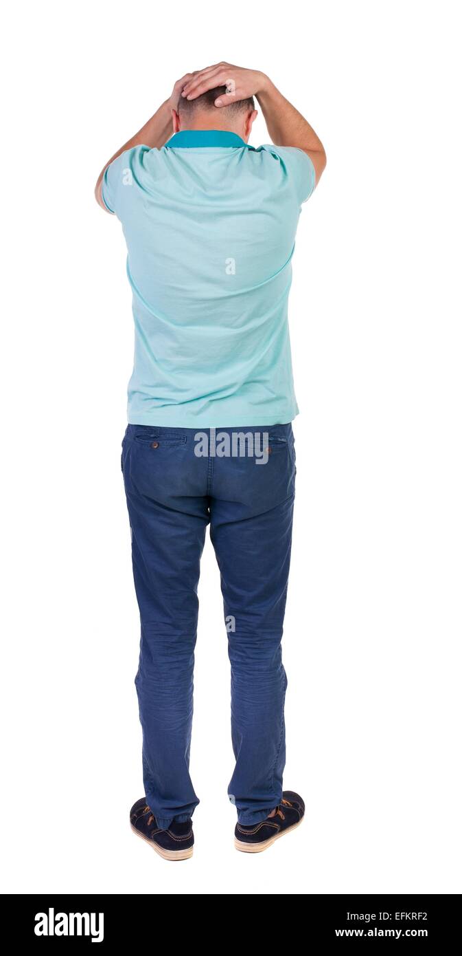 Back view of angry young man in jeans and shirt. Rear view. isolated ...