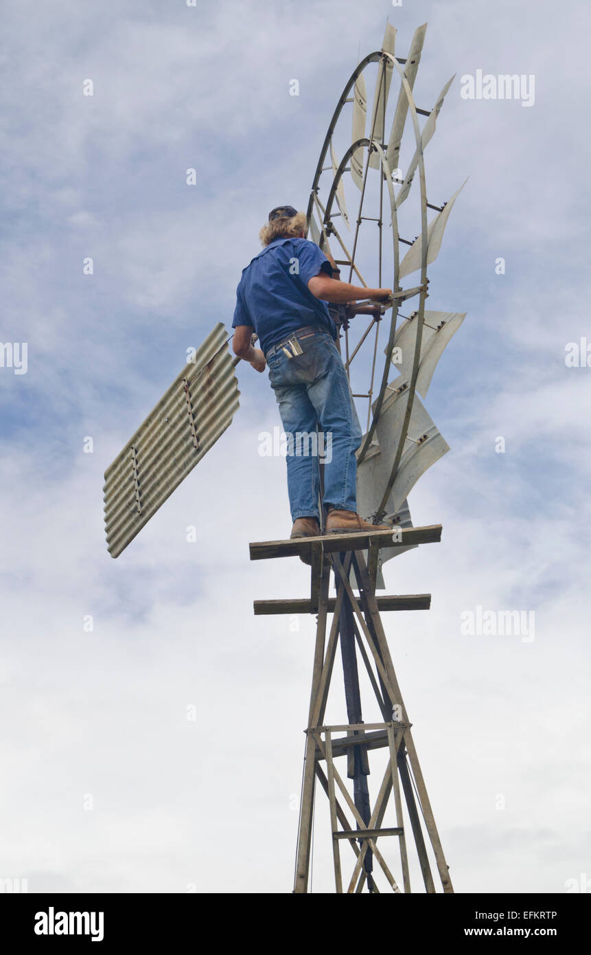 Workman repairing windmill Stock Photo - Alamy