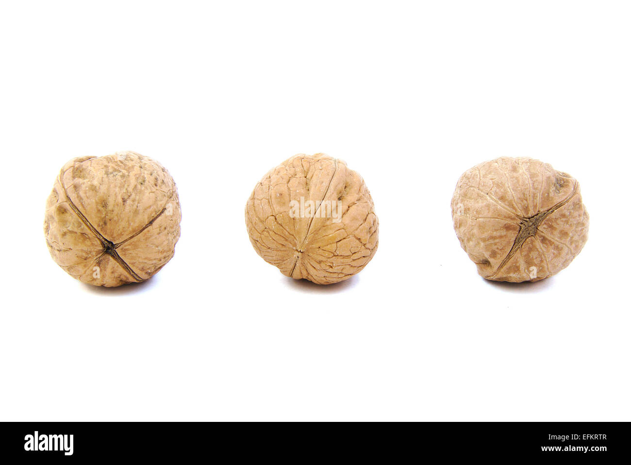 Close-up of three nuts on white background Stock Photo - Alamy