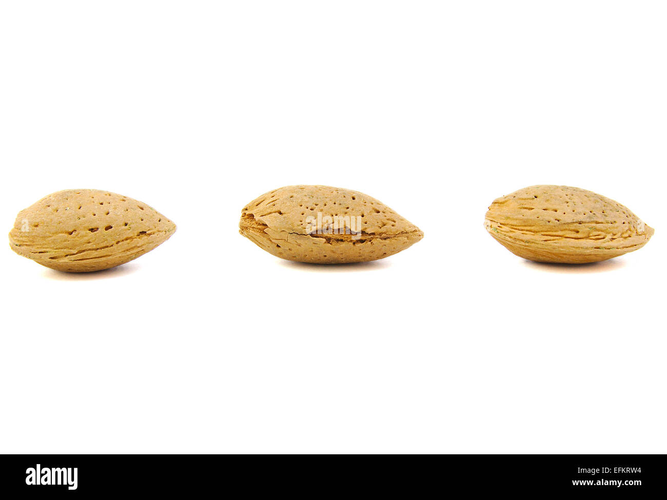 Three almonds on white background Stock Photo - Alamy