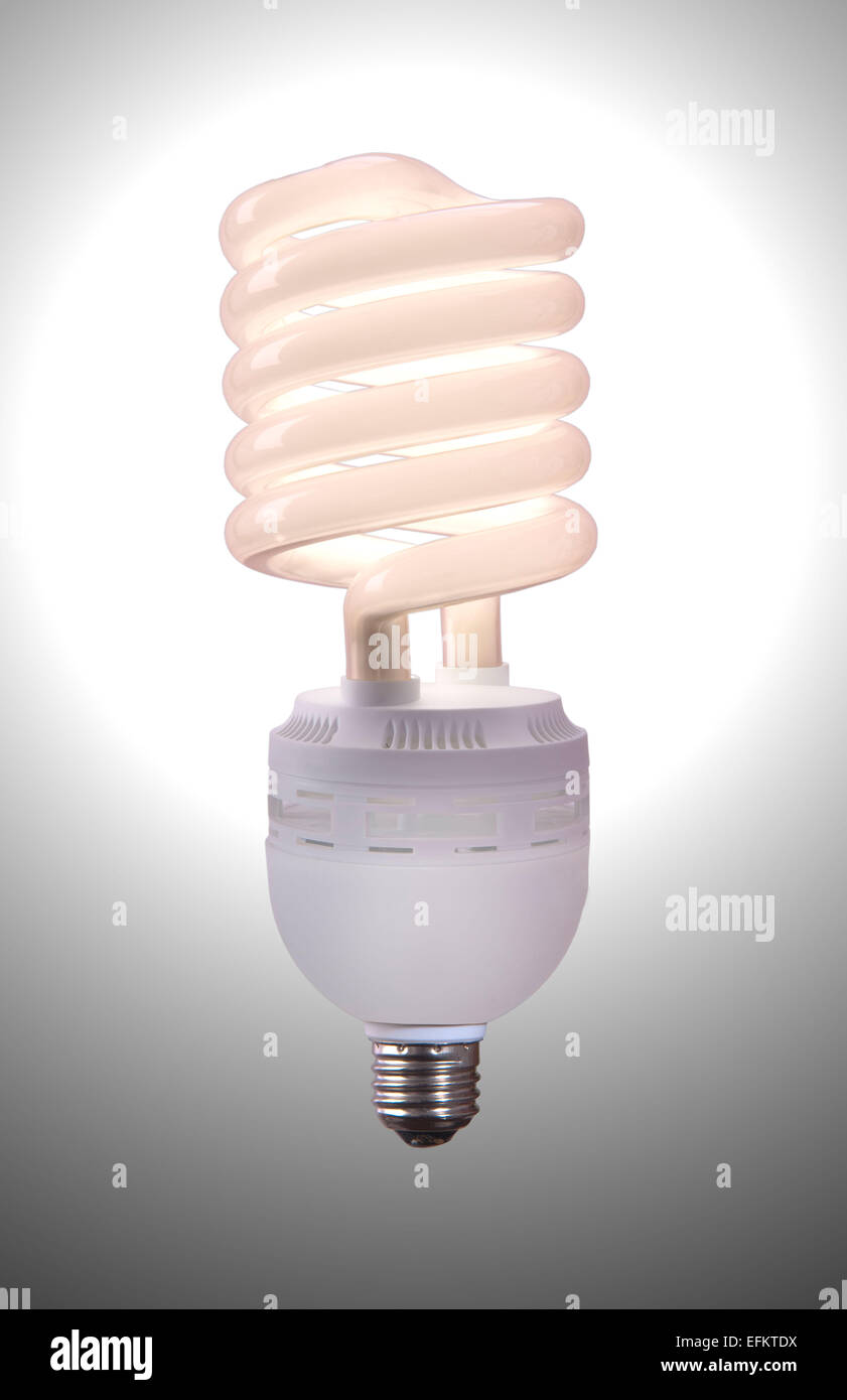 low energy light bulb glowing against a coloured background Stock Photo ...