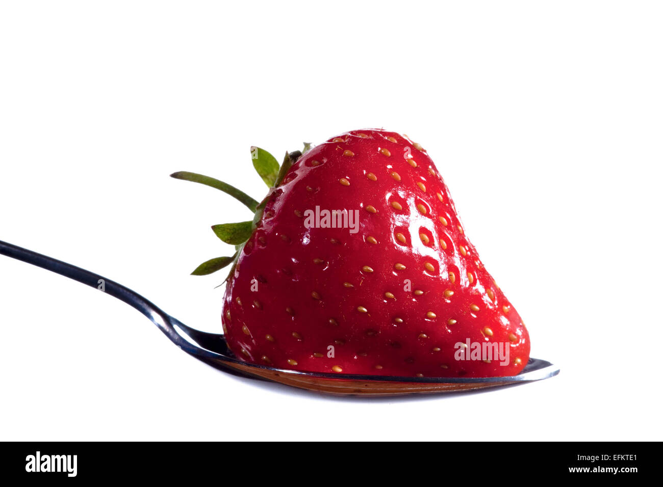 single strawberry on spoon Stock Photo - Alamy