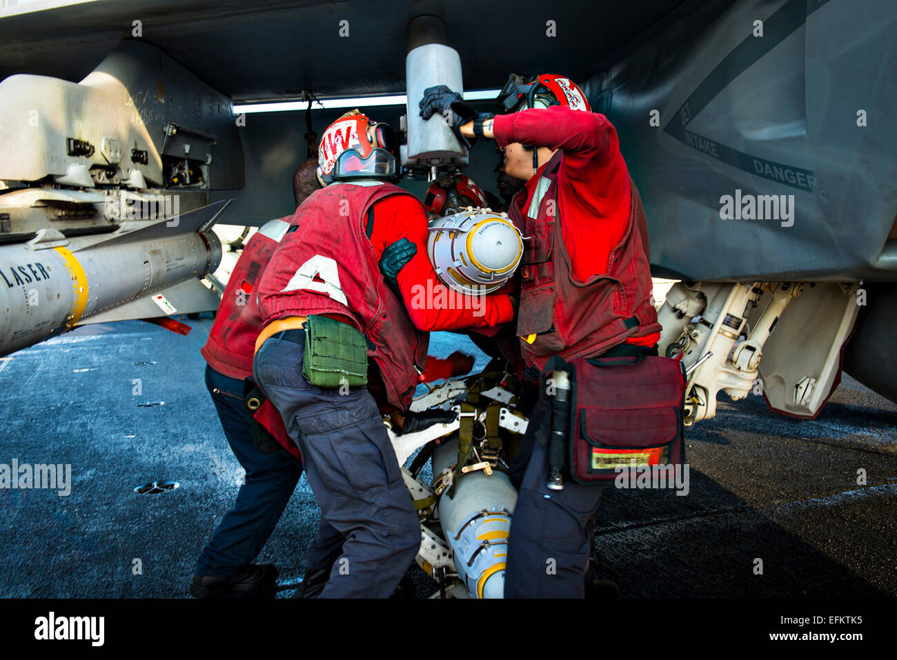 US Navy sailors load a Mk 82/Blu 500 pound bomb onto an F/A-18F Super ...