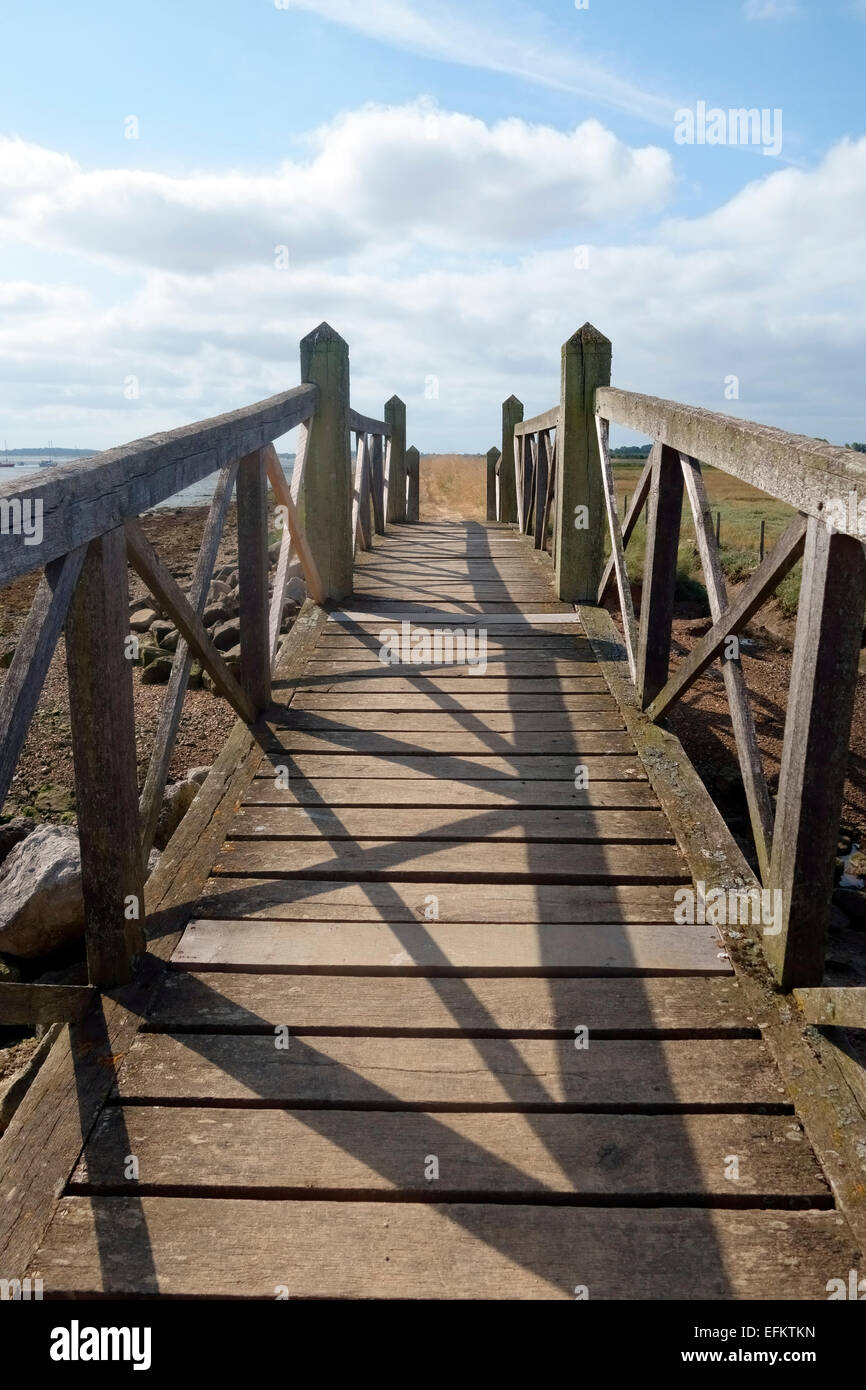 Wooden bridge over a gully on a footpath near Prinsted, West Sussex, UK ...