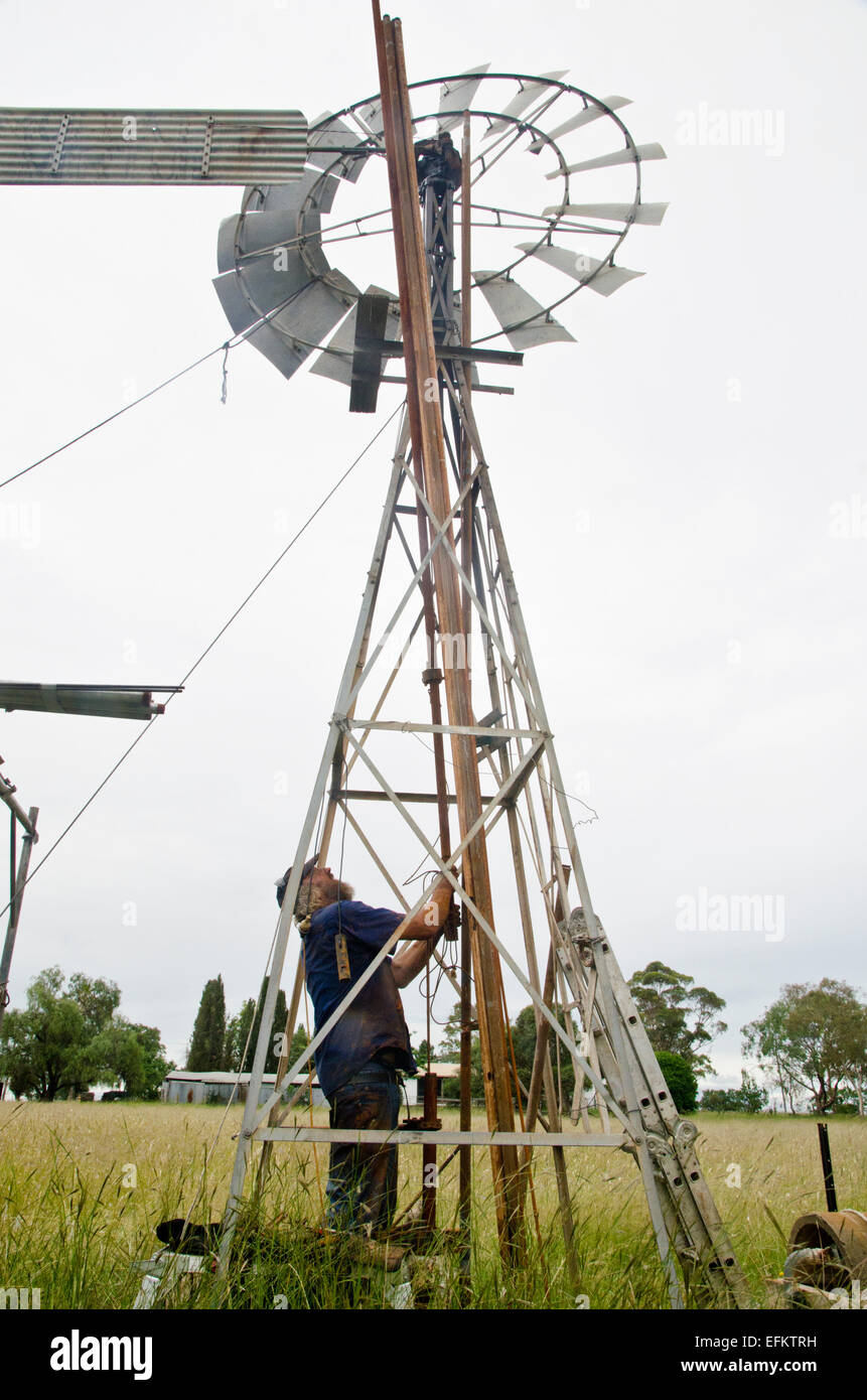 Repairman working on a rural windmill Stock Photo - Alamy