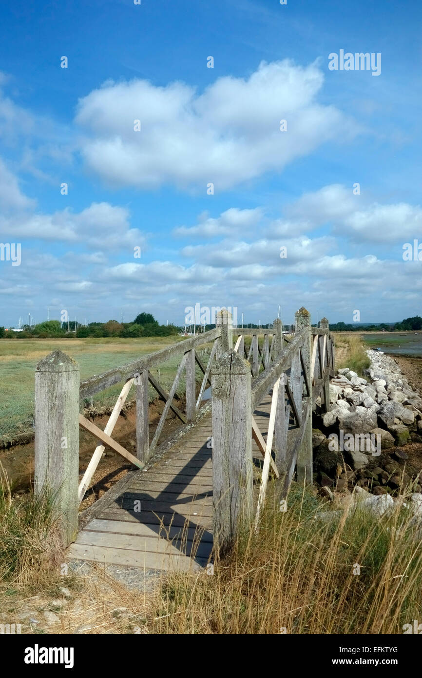 Wooden bridge over a gully on a footpath near Prinsted, West Sussex, UK ...