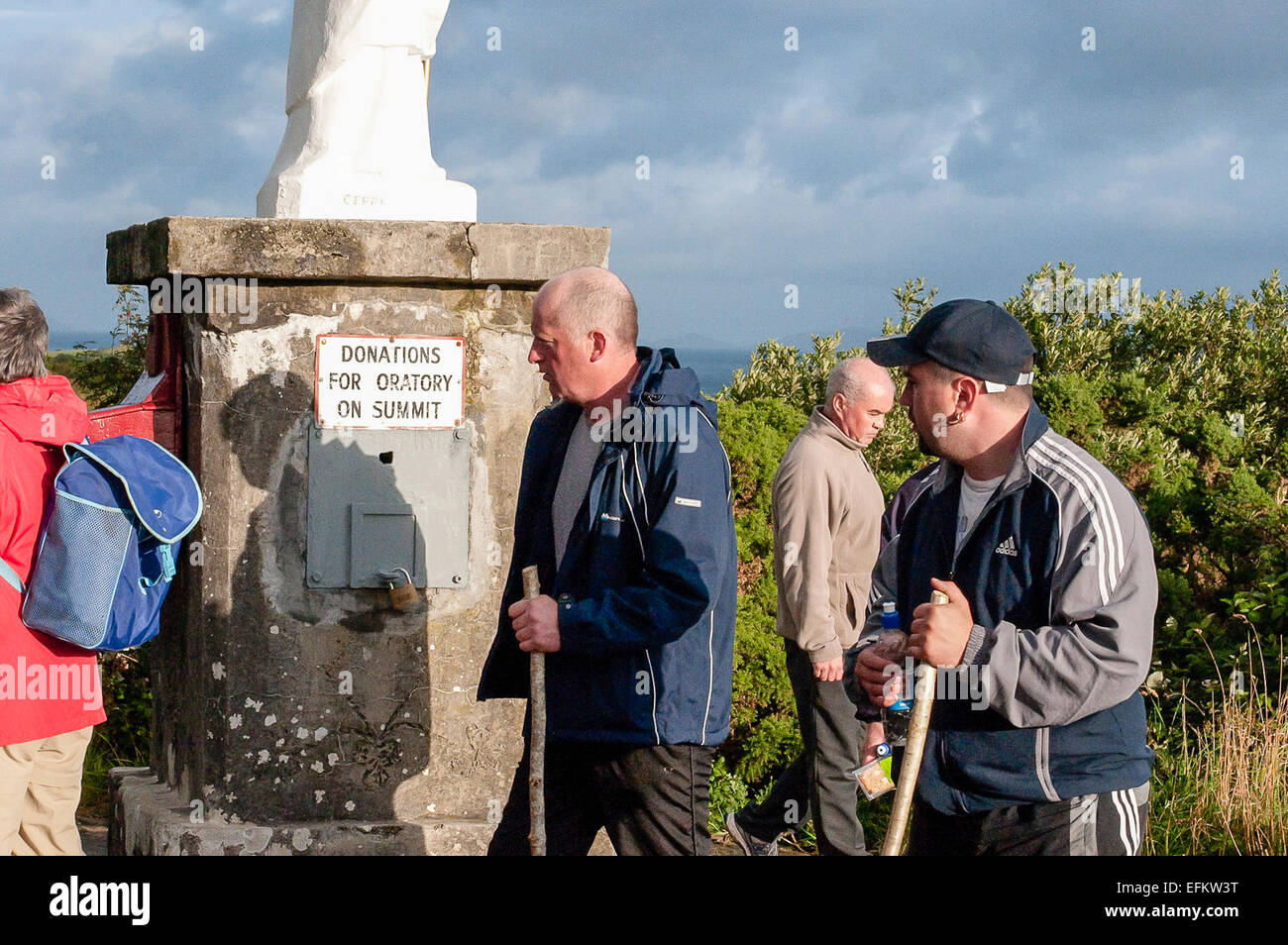 Pilgrims circle statue of St. Patrick 7 times before climbing Croagh ...
