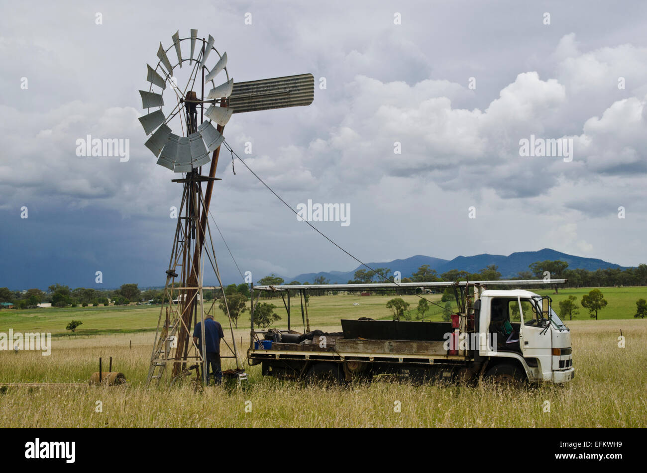 Repairman working on a rural windmill Stock Photo - Alamy