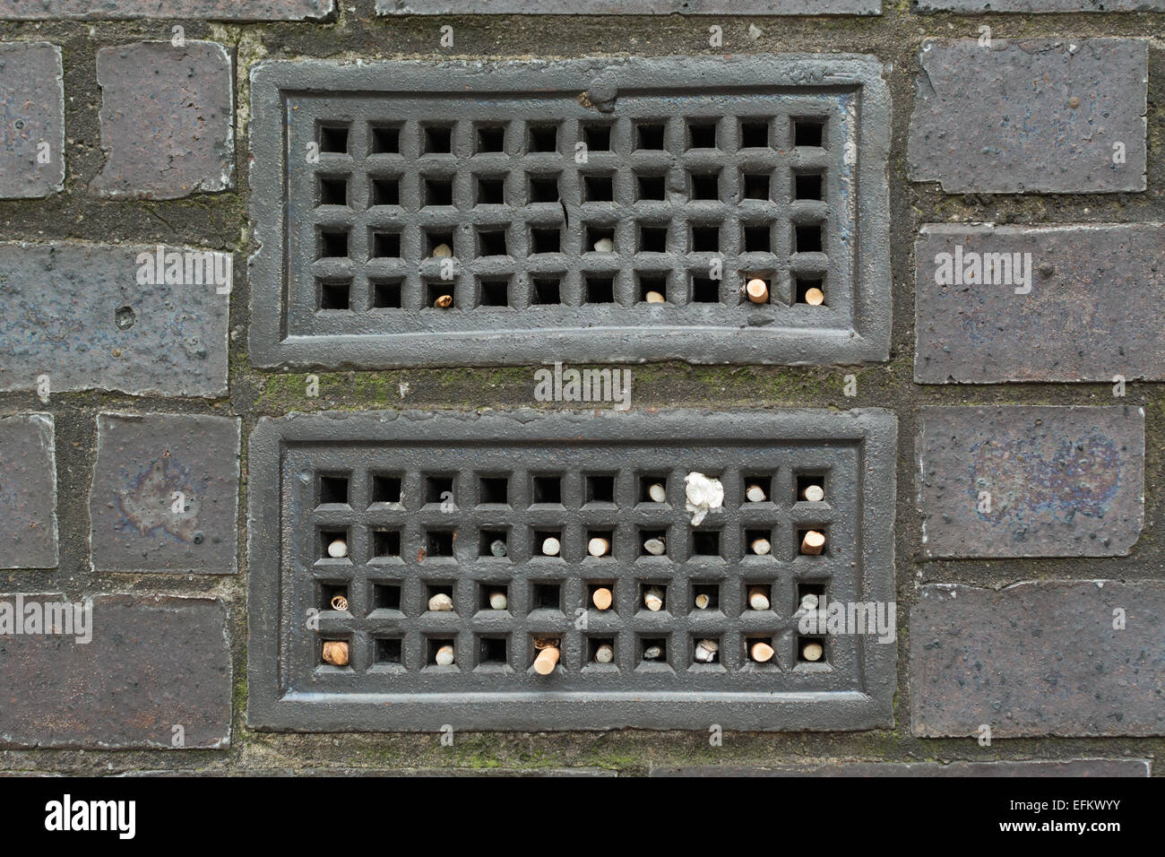 cigarette butts placed inside air brick Stock Photo - Alamy