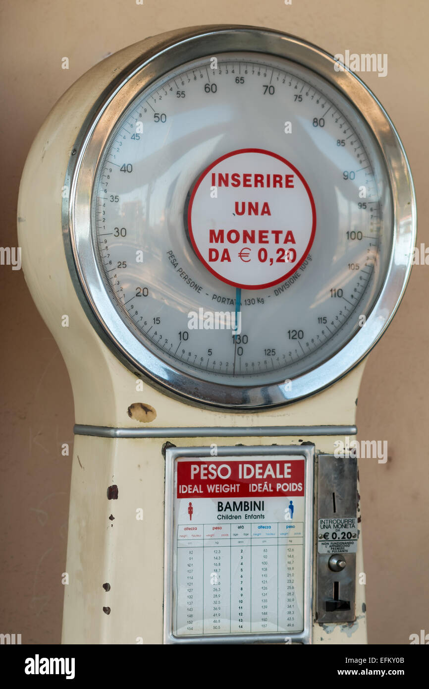 Coin operated weighing scale at train station Stock Photo - Alamy