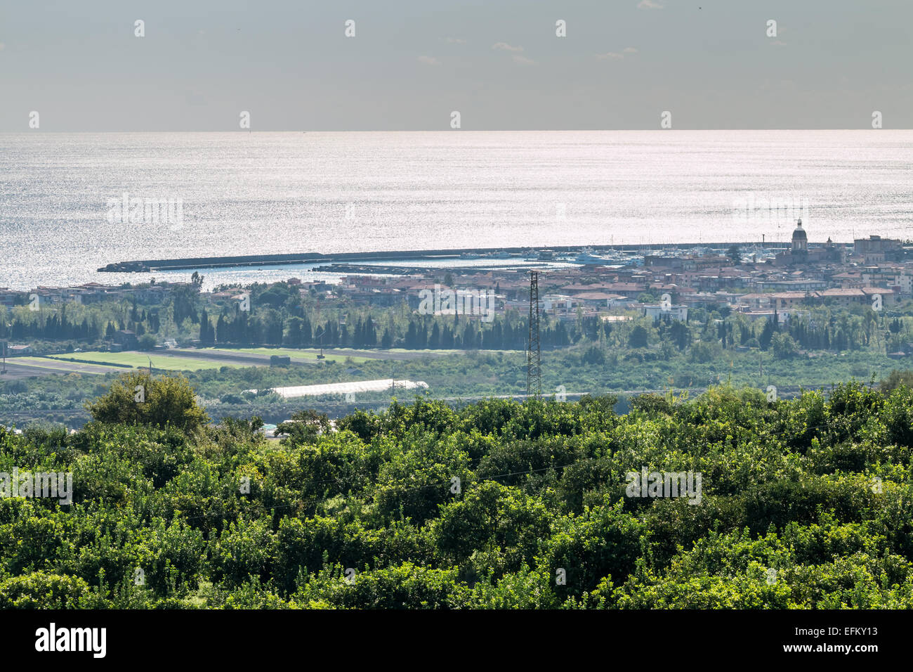 View of Riposto and the marina with the sea shimmering reflections ...