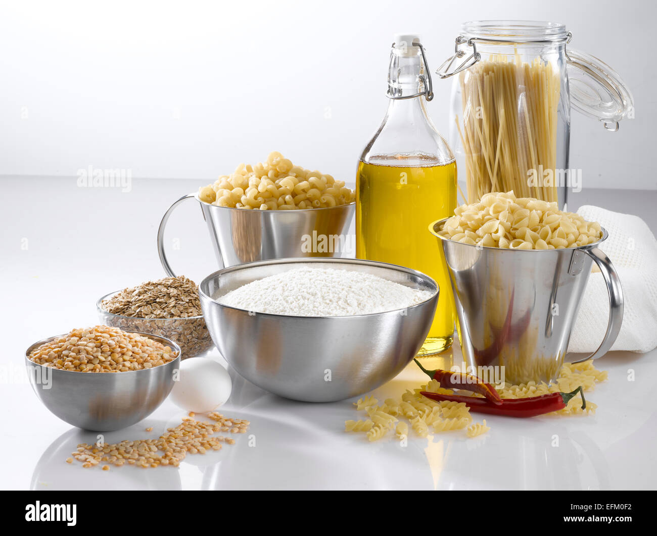 Pasta and serial in bowls, oil in bottle and chilly paper Stock Photo ...