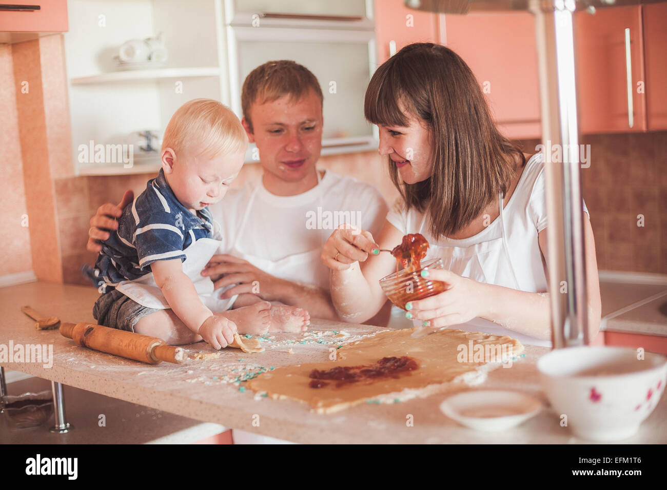 Happy family cooking at kitchen Stock Photo - Alamy