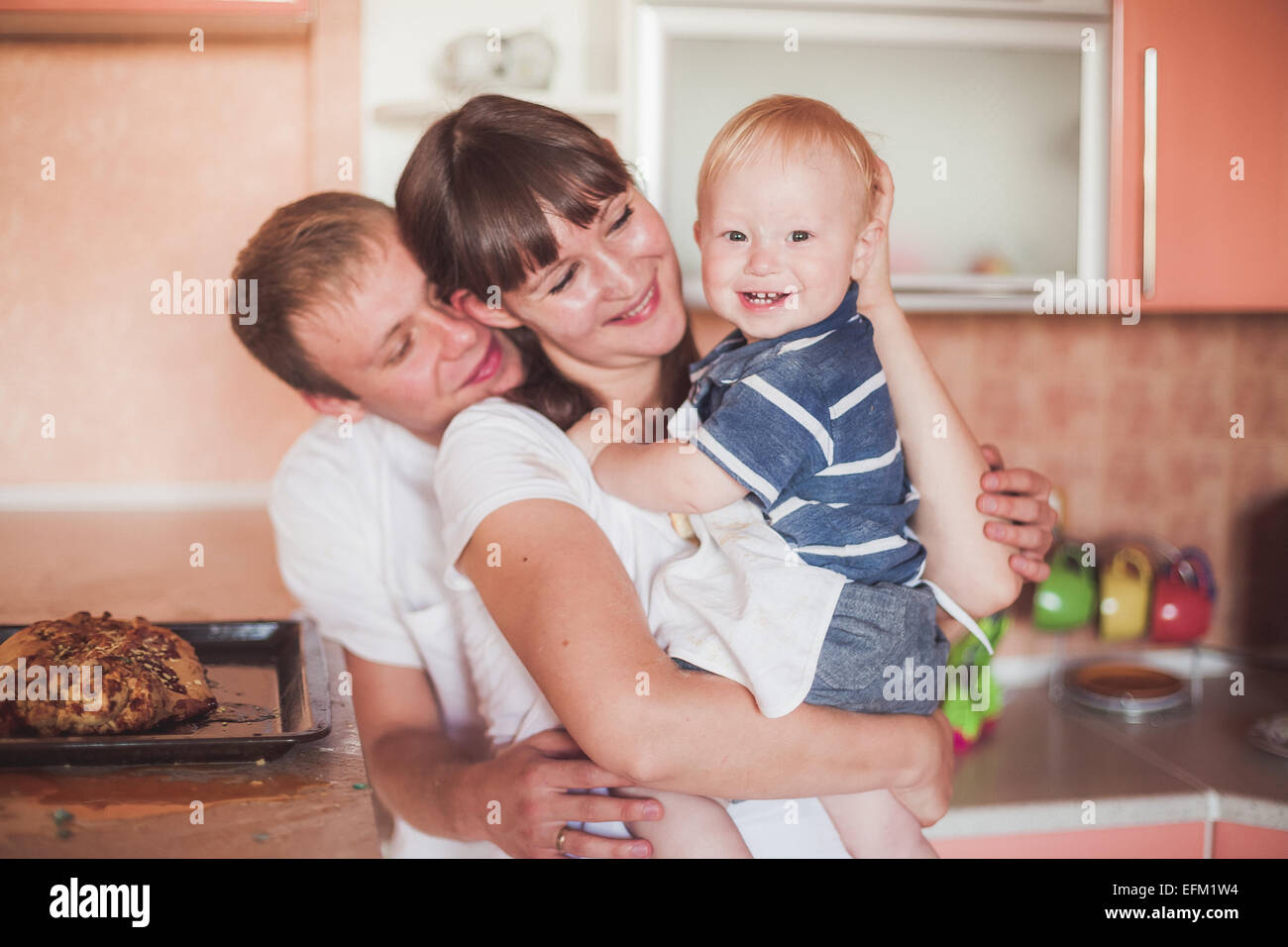 Happy smiling family at kitchen Stock Photo - Alamy