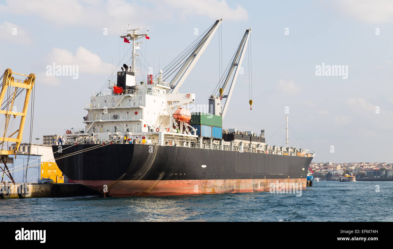 Cargo ship loading in a trading port Stock Photo - Alamy